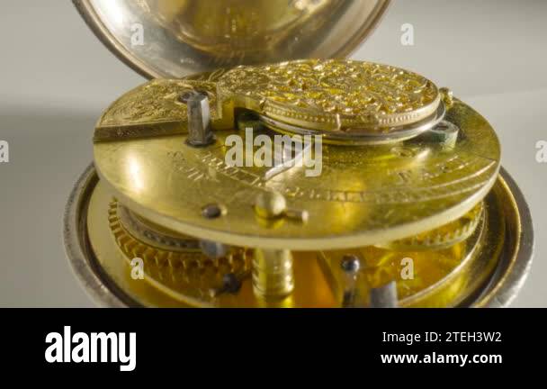 Clockwork mechanism with rotating spring, gears and gearing. Round ...