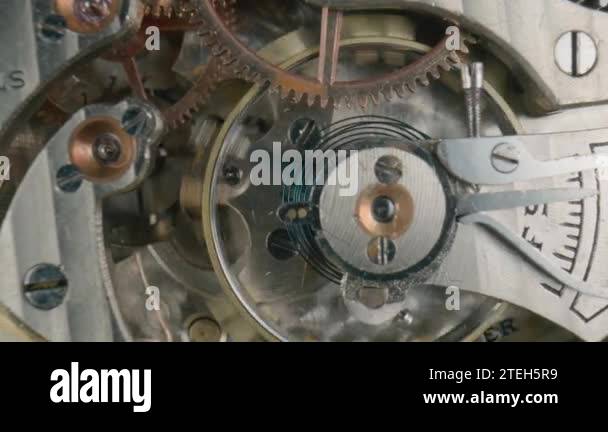 Moving gold gears inside working pocket watch mechanism. Working clock ...