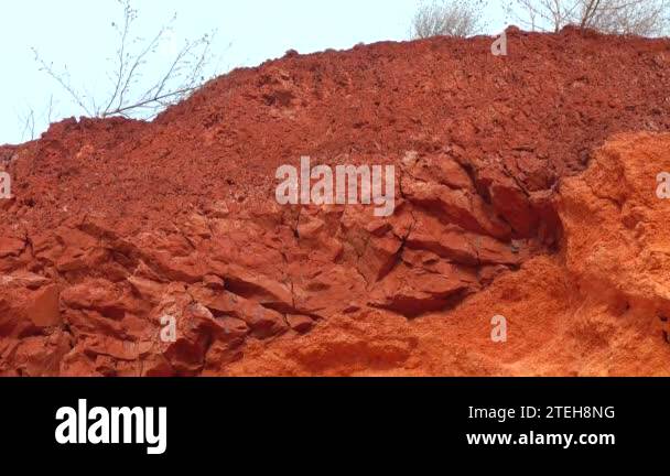 Red clay in the coastal cliff, landslide zone above the beach, Ukraine ...