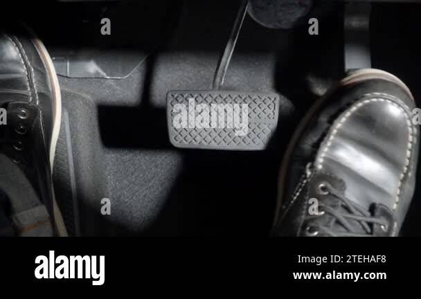 Accelerate and Brake. Foot pressing foot pedal of a car to drive ahead ...