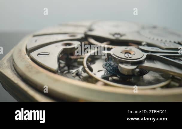 Macro shot of the internal parts of antique pocket watch on a light ...