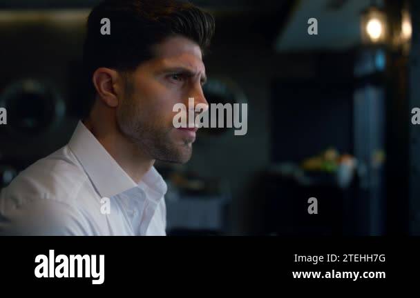 Focused man resting lounge restaurant profile. Handsome ceo manager enjoying free time in dark ...