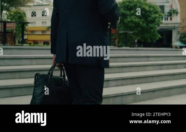 Close up shot of hurry aucasian middle aged businessman running up on ...