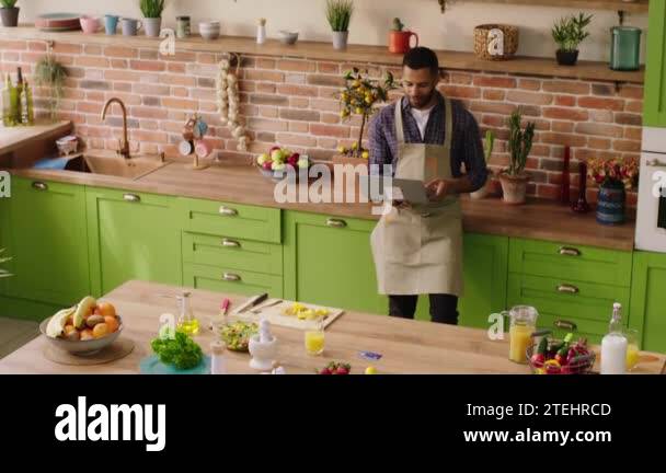 At the modern kitchen taking video form the up guy using the laptop to ...