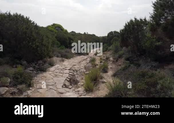 Pov view hiking alone in a ruined path in an adventurous exploration ...