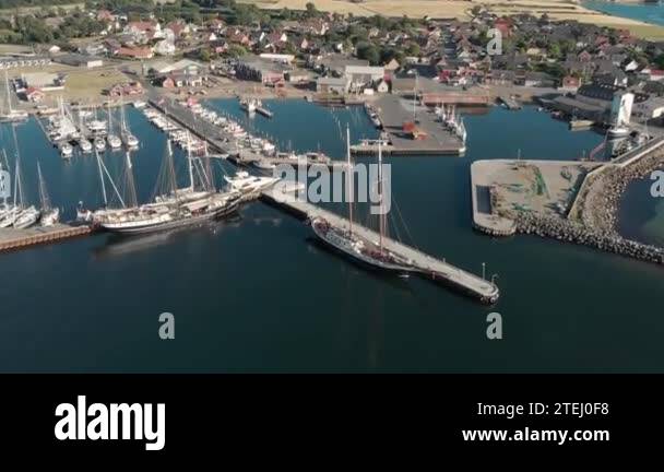 Some ships are laying in a bay of Danmark. You can see some landscape ...