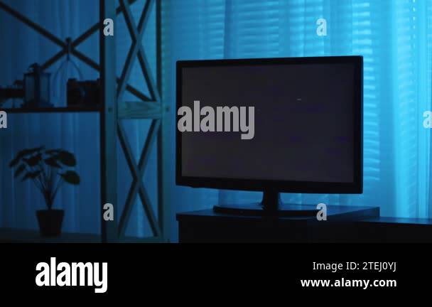 Scratches, dots and lines, flashes of color appear on a dark TV screen ...