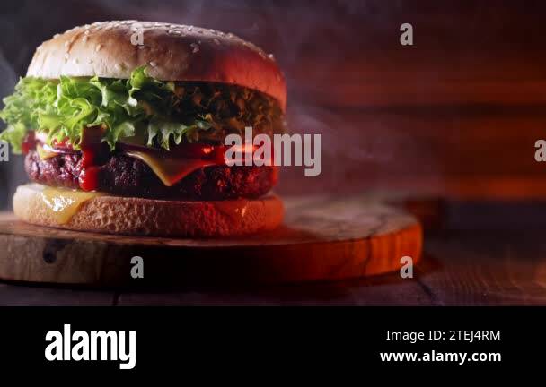 Yummy burger with smoke, fast food concept. Fresh homemade grilled ...