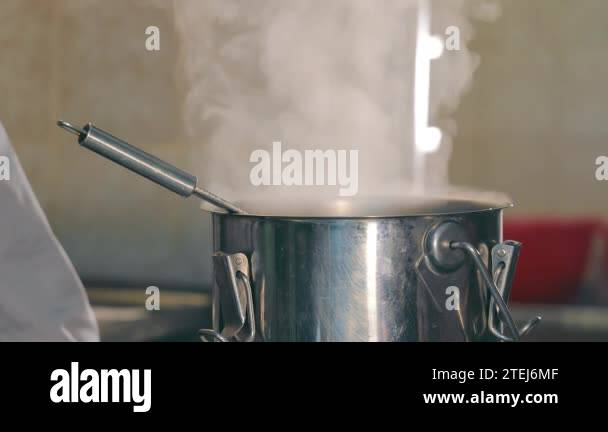 Cooking in a fast food dining room. Steam coming from a bath in which ...