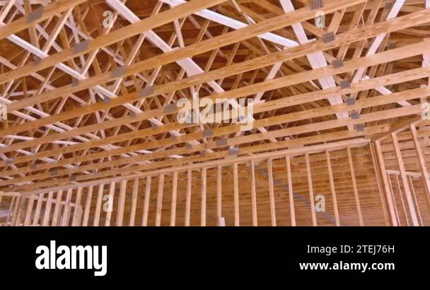 The roof trusses of a new residential building under construction are ...