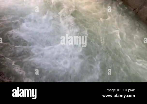 Stream of fresh river water splashing while flowing through rocks Stock ...