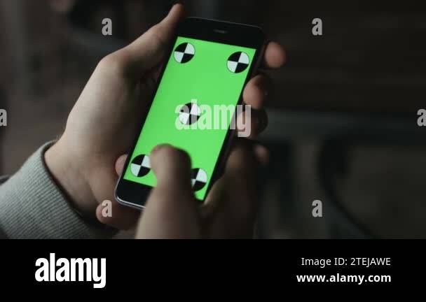 Close-up of male hands touching of smartphone. Green screen Chroma Key ...