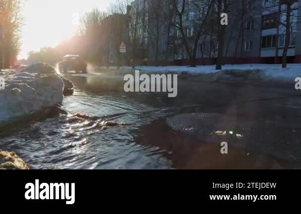 Puddle. Poor operation of sewer system. Dirty water melted from snow ...