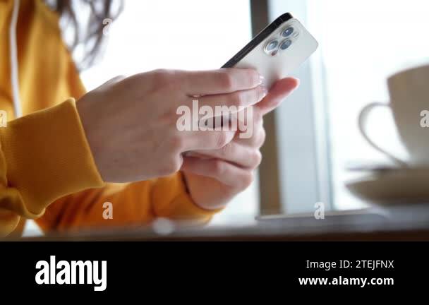 Girl using iPhone 12 smartphone pressing finger, reading social media ...