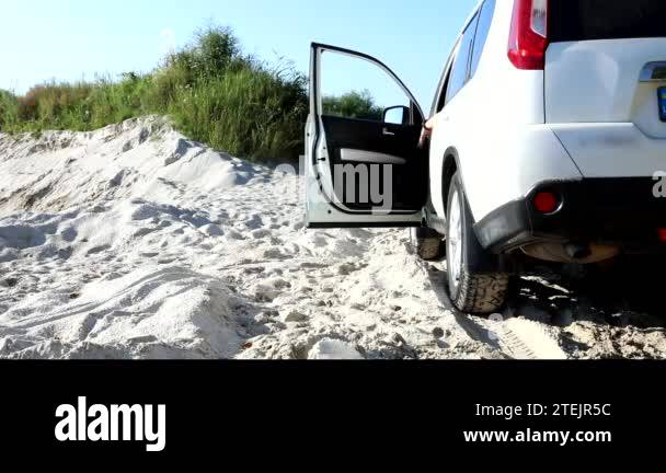 man going out from the car in flippers at sandy beach summer vacation ...