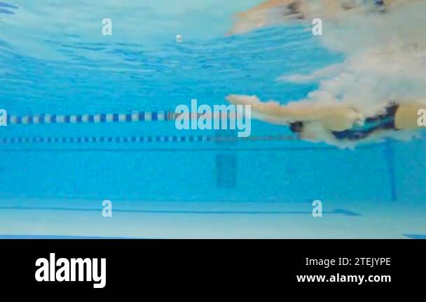 Woman athlete swims underwater in the pool. Slow motion of a female ...