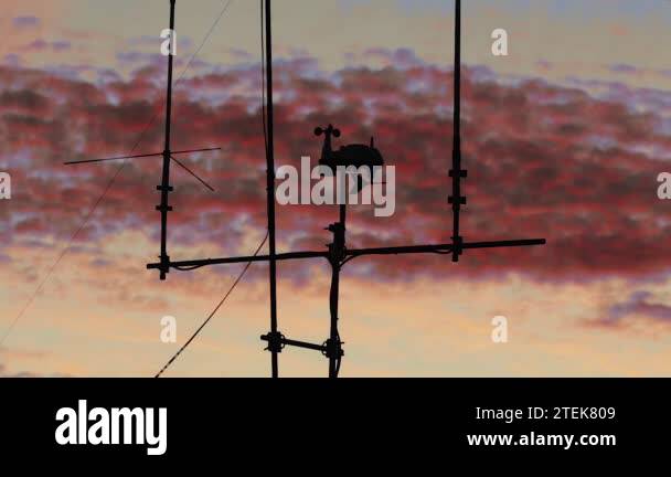 Tilt up from a weather station and ham radio aerials mounted on a pole ...