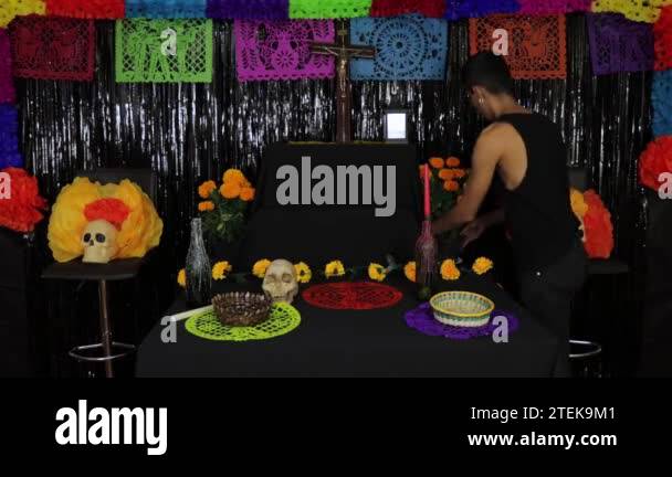 Making the offering for day of the dead. Mexican model with brown skin ...