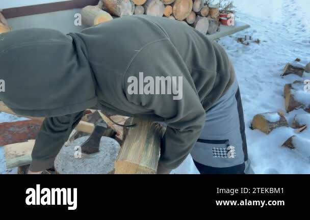 Man taking and holding pile of chopped fire wood prepared for winter ...