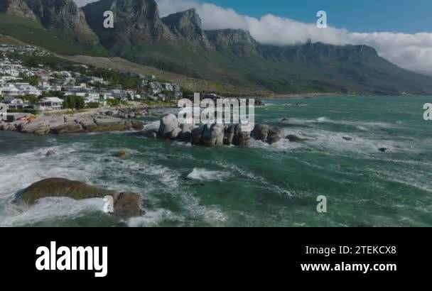 Waves washing coastal rocks. Large rounded stone blocks at shore ...
