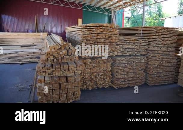 Wood warehouse. Sliced wooden boards are stored in a trading warehouse ...