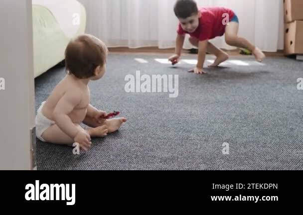 The boy and the girl, playing catch-up, crawling on their hands and ...