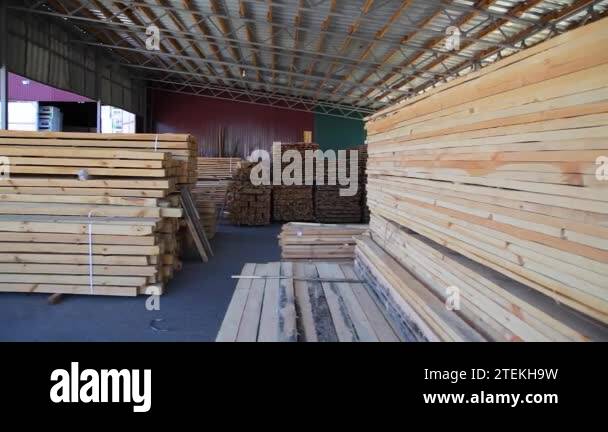 Wood warehouse. Sliced wooden boards are stored in a trading warehouse ...