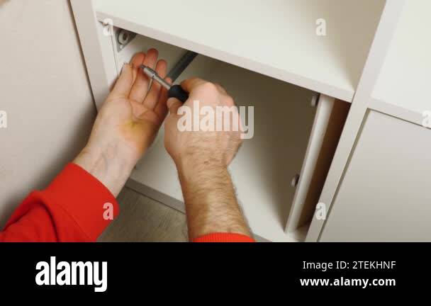 A Close Up Of A Mans Hands Screwing A Self Tapping Screw Inside A