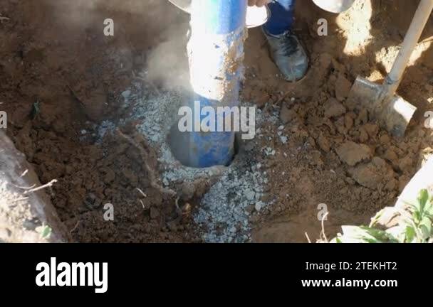 Installing a well, pouring crushed stone into a hole, an industrial ...