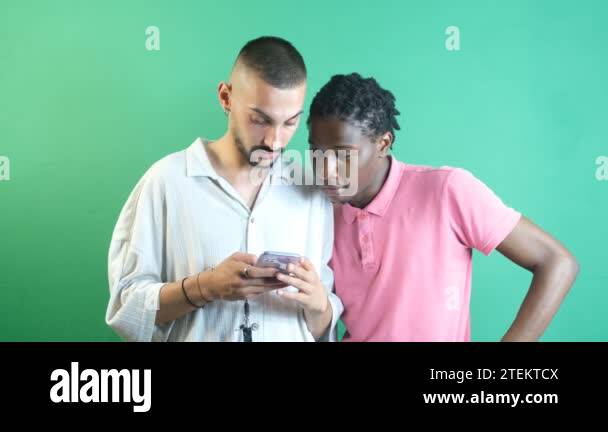 Two male friends watching fun things on the phone, image of emotions ...