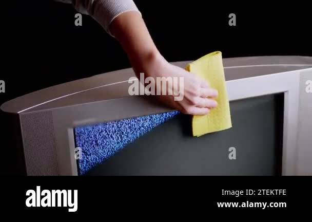 Female Hand Wipes Dust with a Yellow Rag from Surface of an Old TV in ...