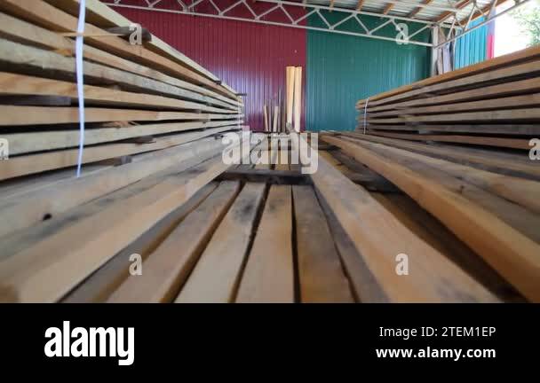 Wood warehouse. Sliced wooden boards are stored in a trading warehouse ...