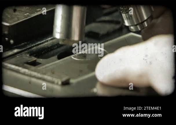 Close up of hand positioning plastic examination plate with drop of ...