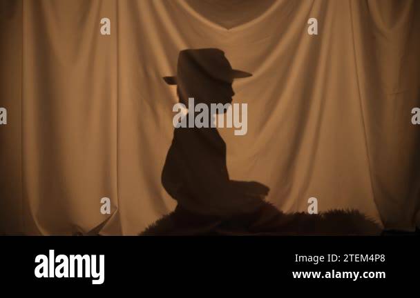 Silhouette of little boy wearing cowboy hat and holding toy gun. Child ...