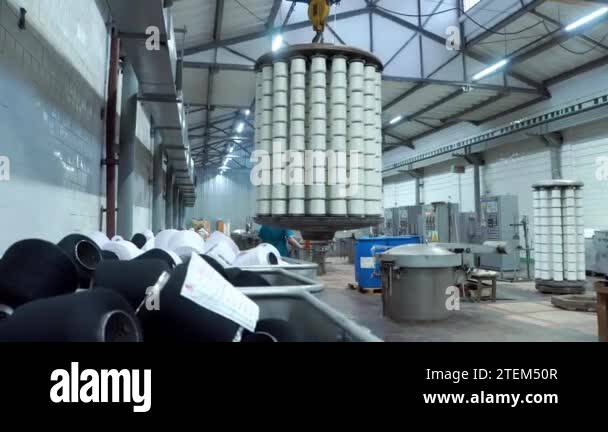 Textile factory female worker works with thread coloring machine ...