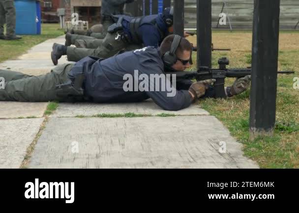 Police officer shoots an assault rifle during target practice at a gun ...