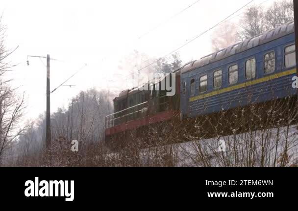 Steam locomotive train approaching station passing through a goods yard ...