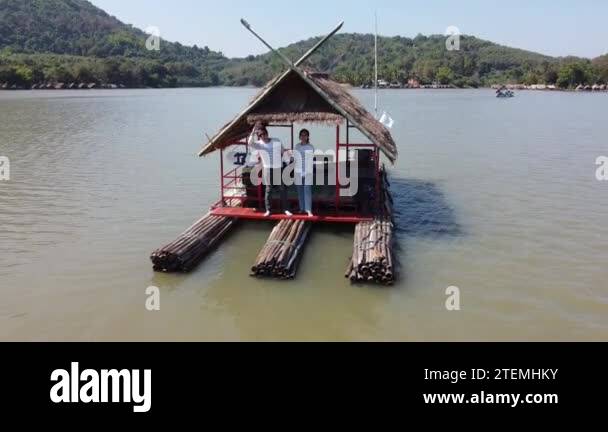 Couple in Area of Huai Krathing reservoir with bamboo raft shelter for ...