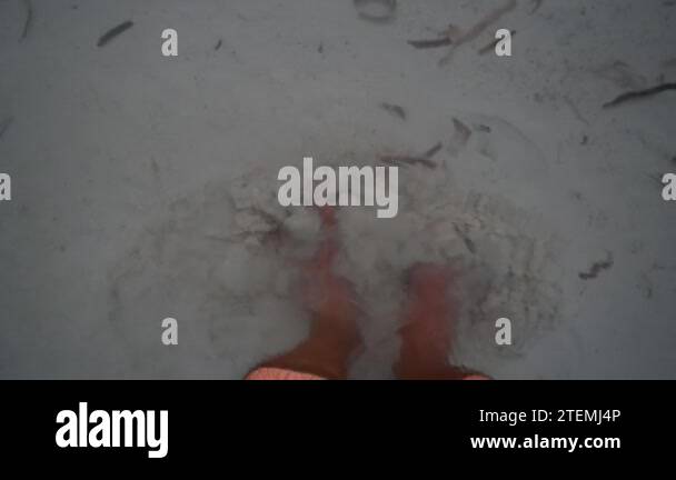 Video of a man's feet in the water. The movement of feet in the white ...