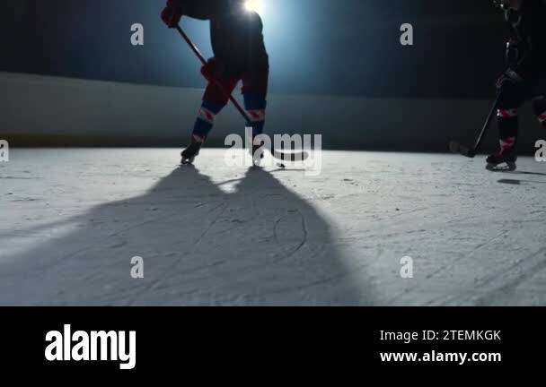 Two men hockey player masterfully dribbles, hitting puck with stick and ...