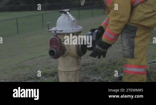 Firefighter places a piece of firefighting equipment to attach a fire ...