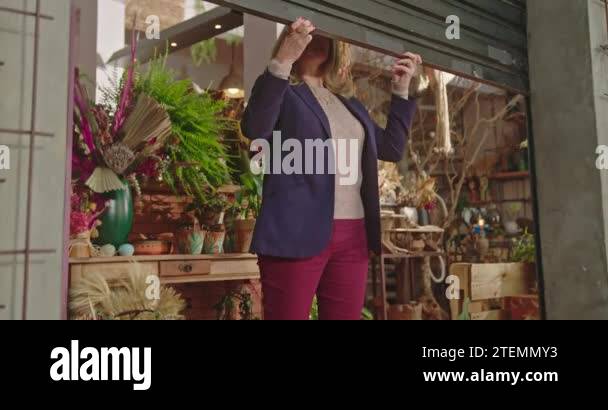 Small business owner opening local store. Female entrepreneur sliding ...