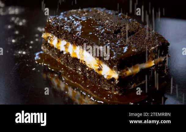 An Indian chef dusting powdered sugar over delicious chocolate cake ...