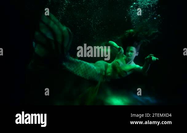 dark and mysterious deepness of magical sea or lake, mermaid is ...