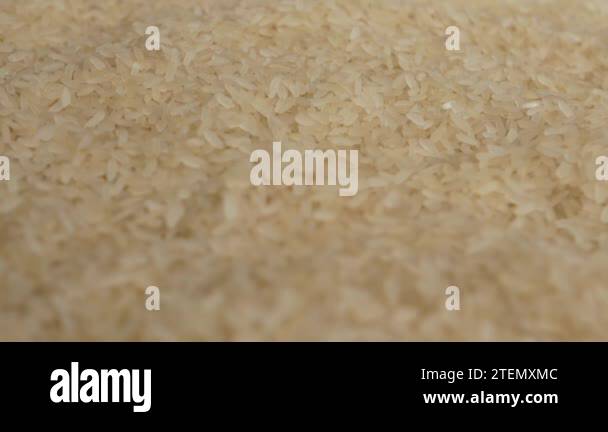 A pattern of grains of peeled white rice. The edges of the frame are ...