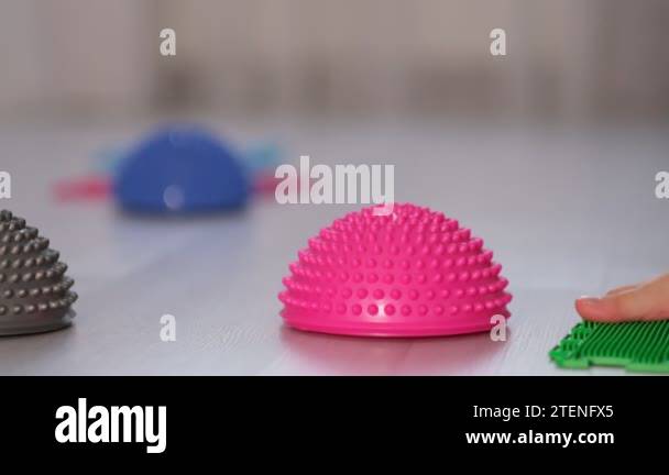 legs of a small child on orthopedic mats. Bright surfaces for walking ...