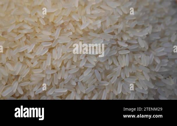 Full frame background of raw white rice rotating on turn table. View ...