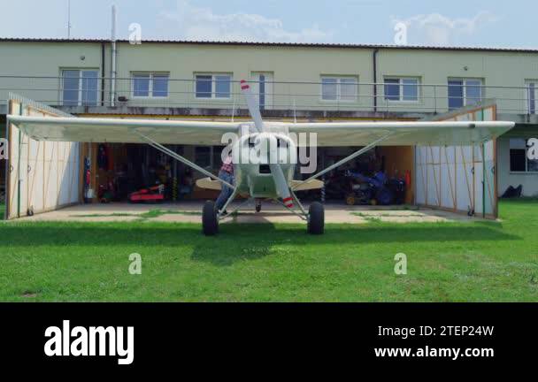 Small airplane leaving hangar controlled by professional pilot sunny ...