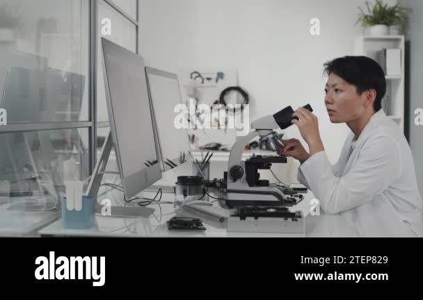 Lab technician using microscope Stock Videos & Footage - HD and 4K ...