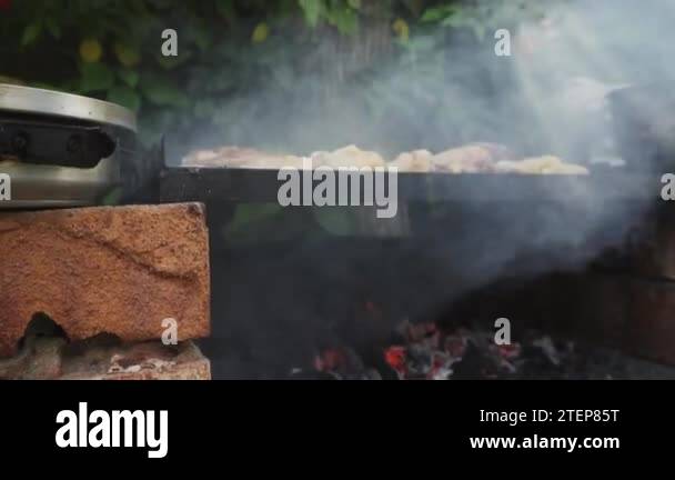 close-up of the fire flames of a grill exploding in the coal and ...